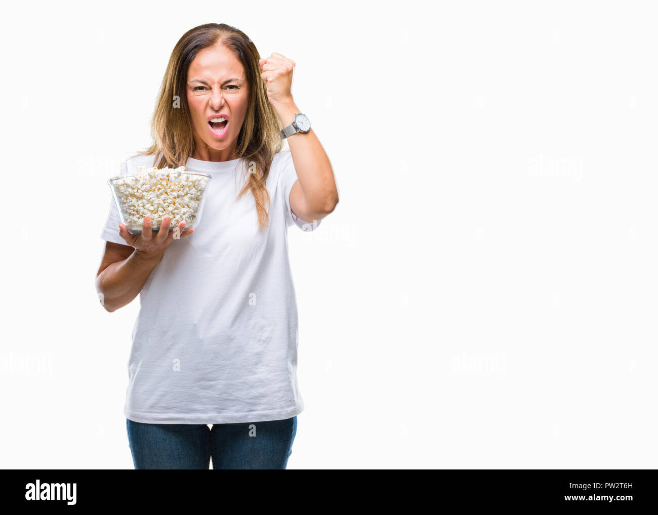 Middle age hispanic woman eating popcorn over isolated background ...