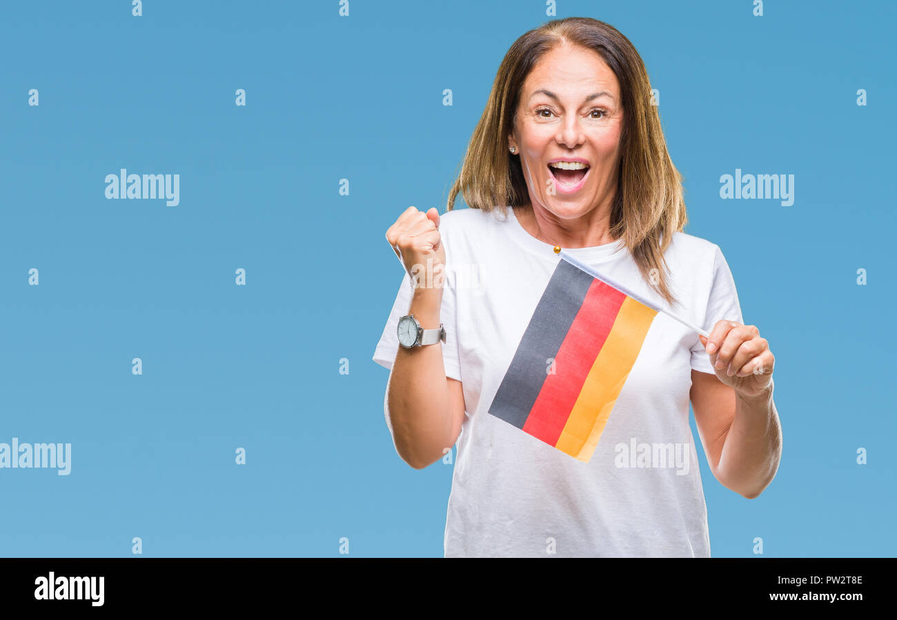 Middle age hispanic woman holding flag of Germany over isolated ...
