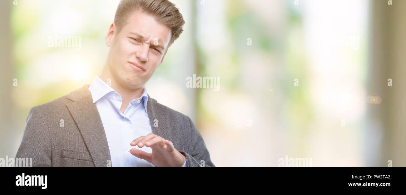 Young handsome blond business man disgusted expression, displeased and ...