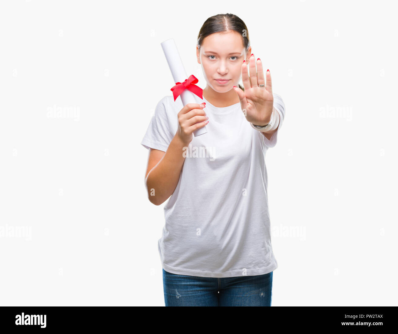 Young caucasian woman holding degree over isolated background with open ...