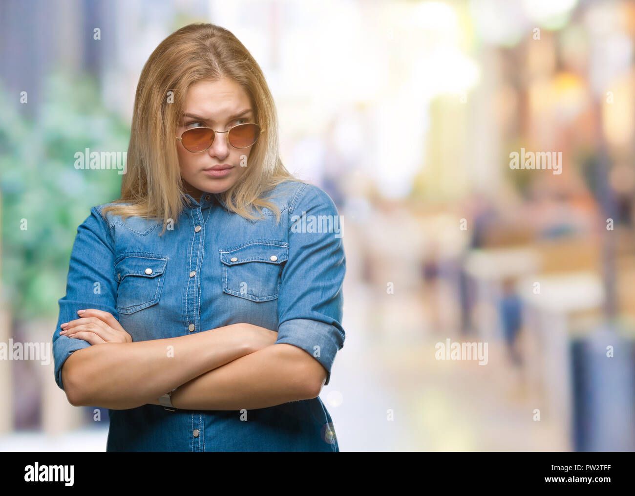 Young caucasian woman wearing sunglasses over isolated background ...