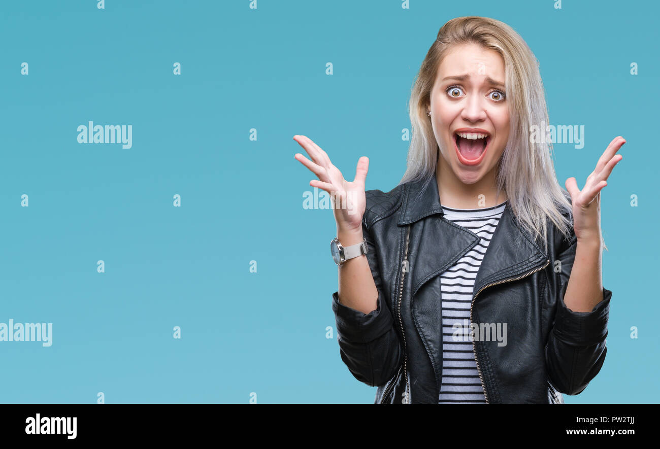 Young blonde woman wearing fashion jacket over isolated background ...