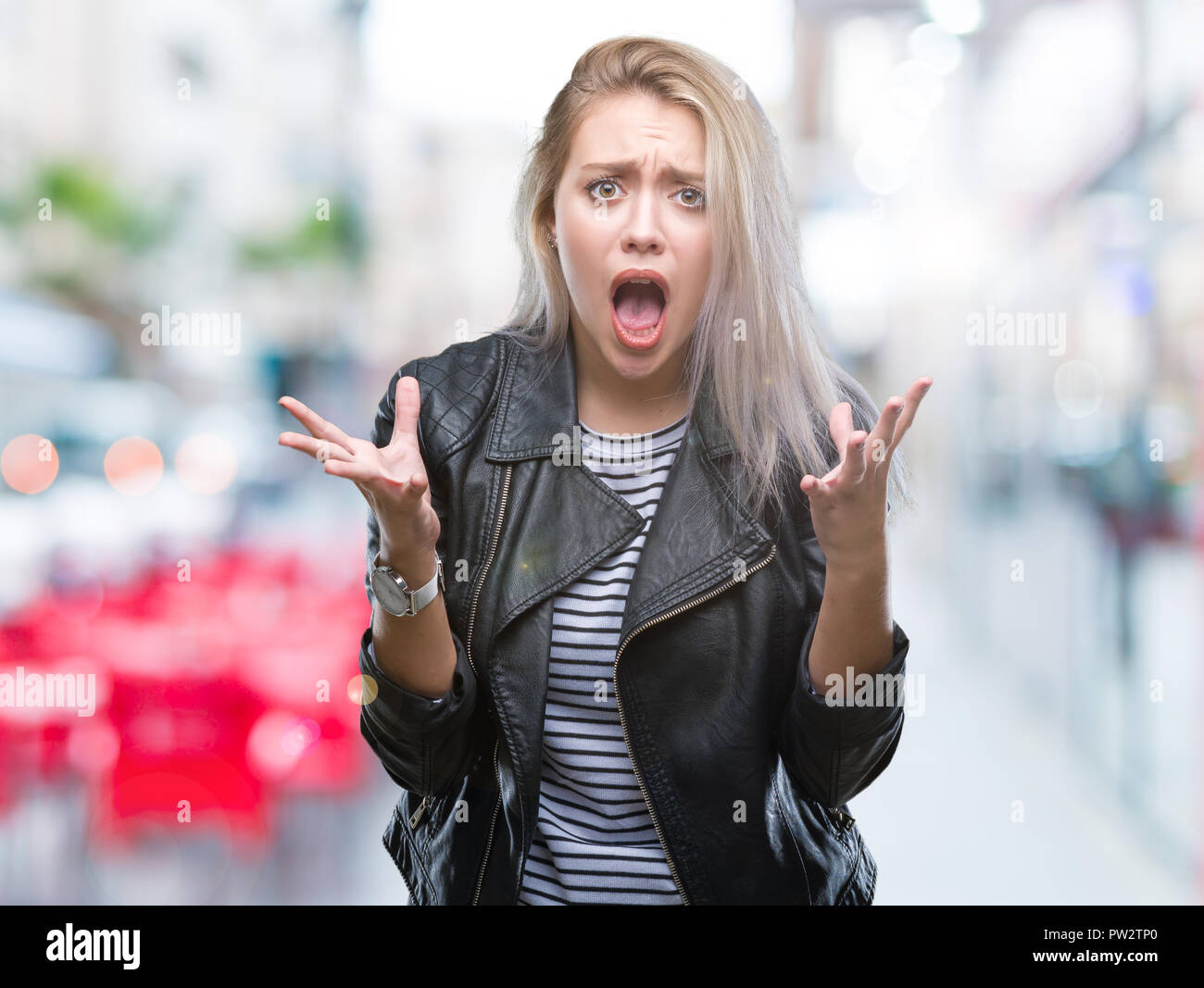 Young blonde woman wearing fashion jacket over isolated background ...