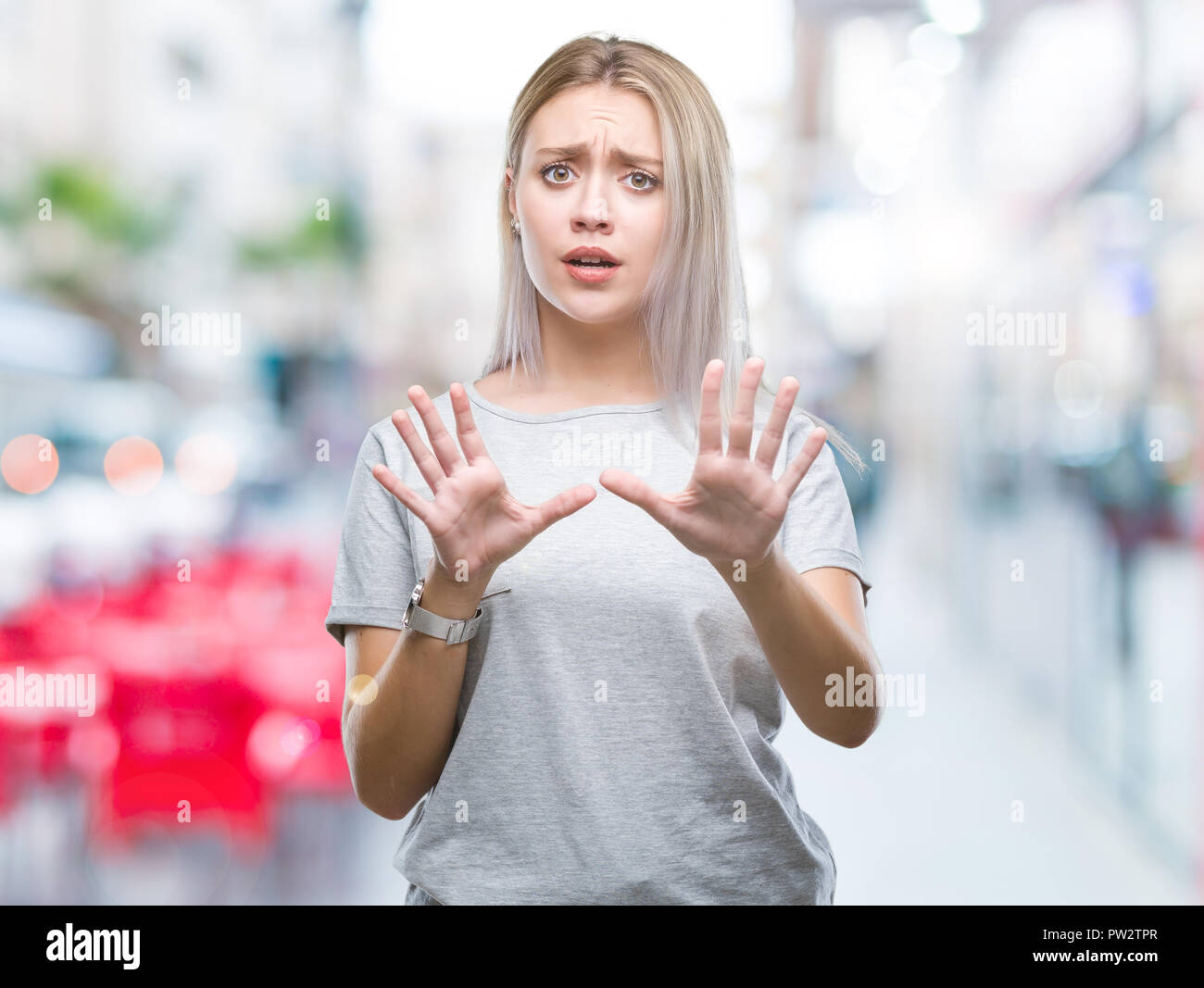 Young blonde woman over isolated background afraid and terrified with ...