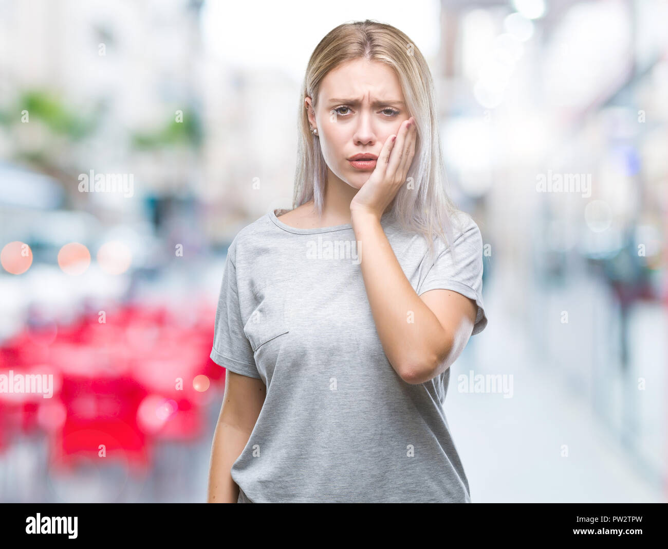 Young blonde woman over isolated background touching mouth with hand ...
