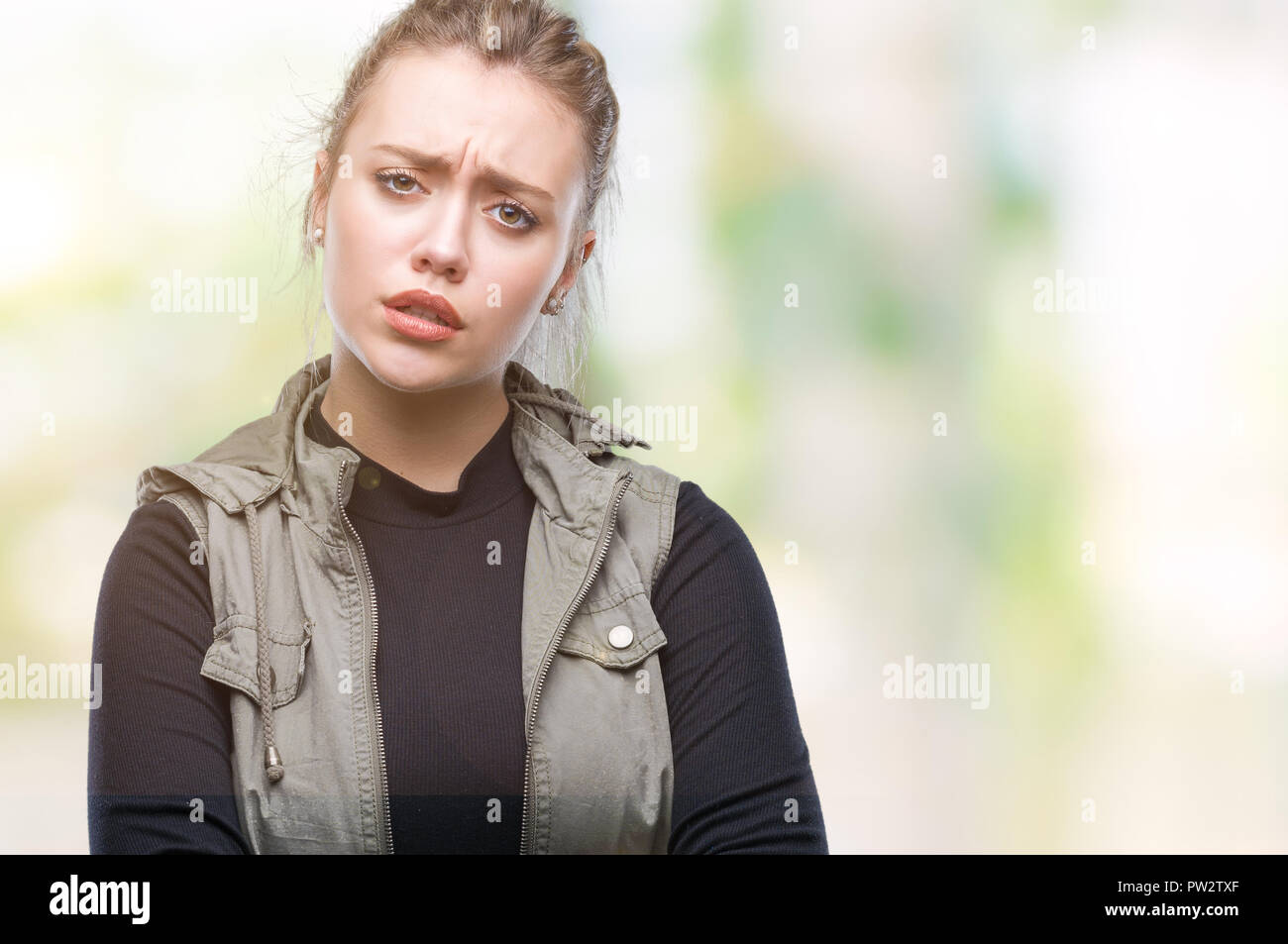 Young blonde woman over isolated background skeptic and nervous ...