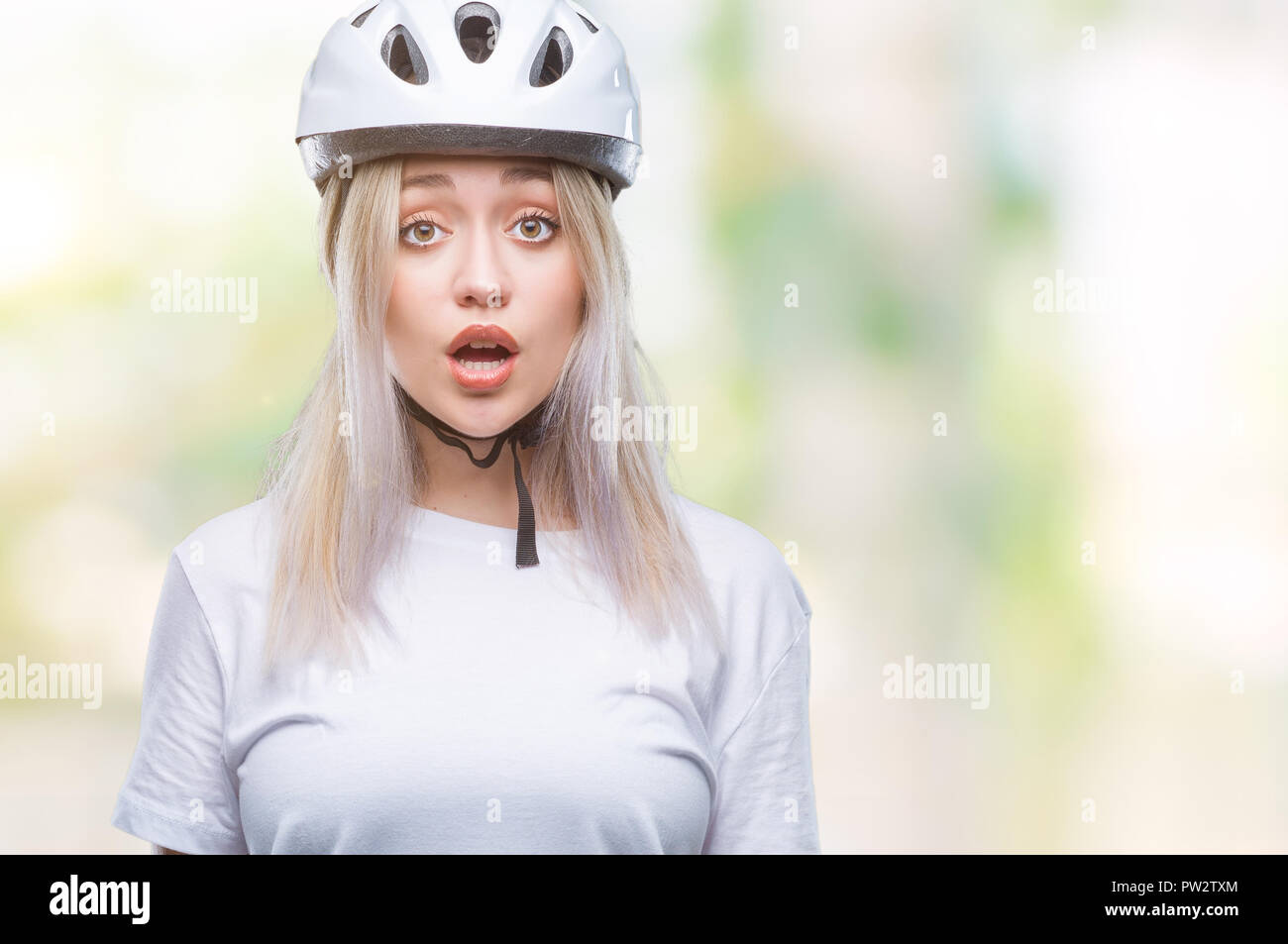Young blonde woman wearing cyclist security helmet over isolated ...