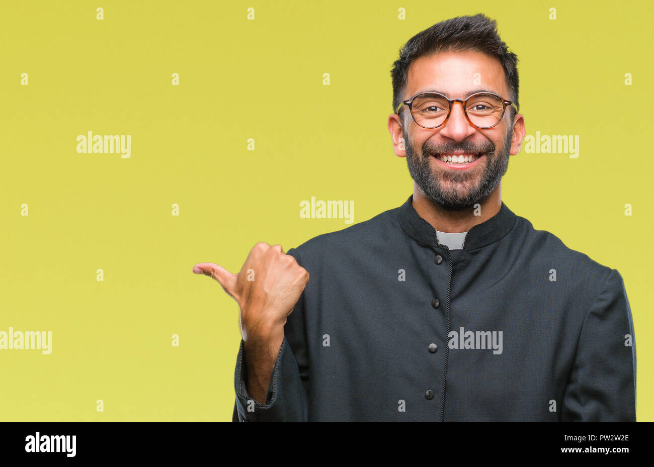 Adult hispanic catholic priest man over isolated background smiling ...