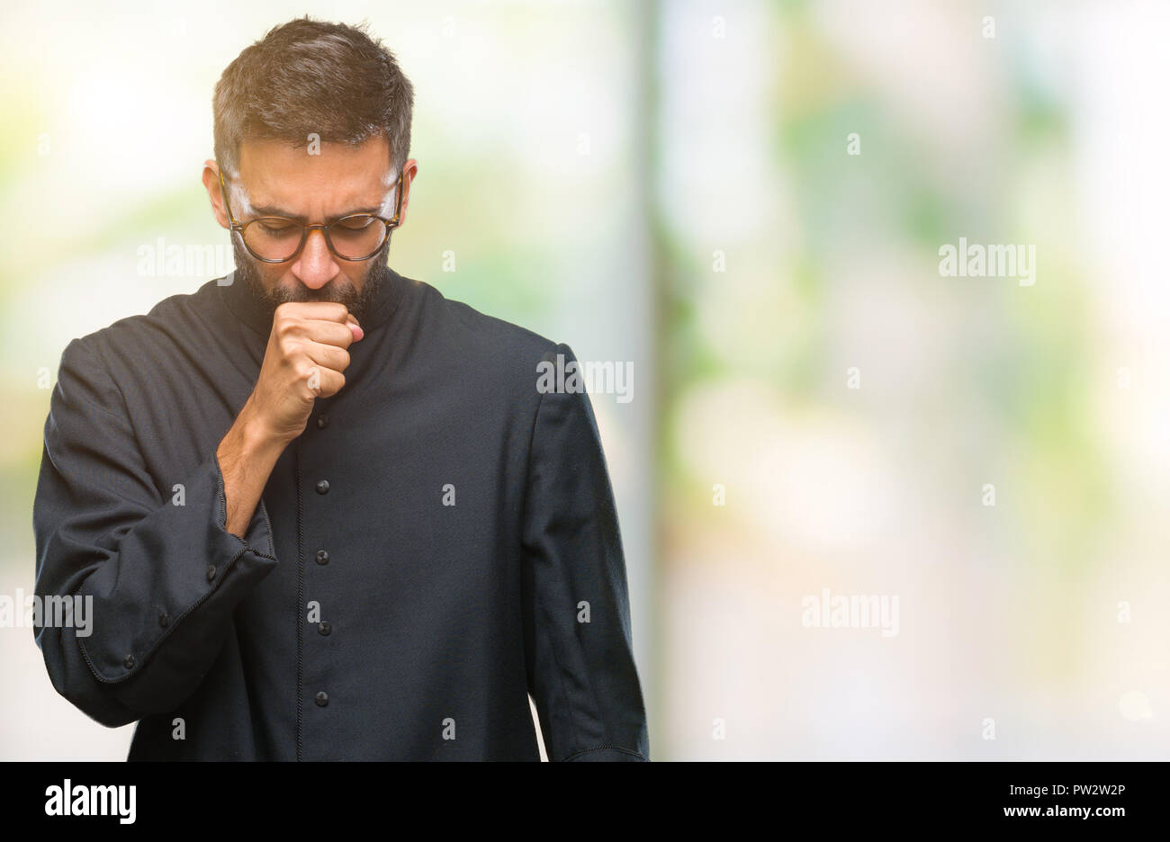 Adult hispanic catholic priest man over isolated background feeling ...