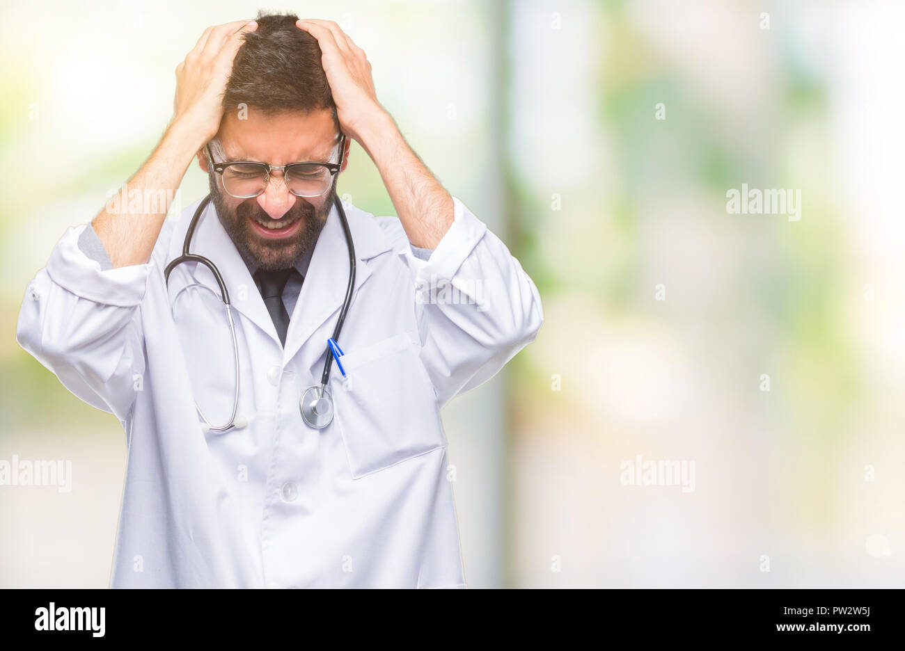 Adult hispanic doctor man over isolated background suffering from ...