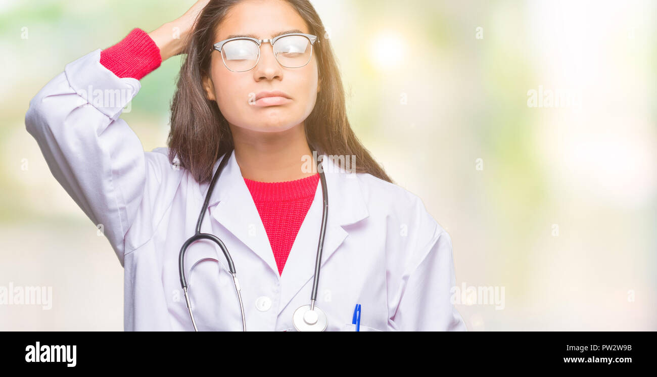 Young arab doctor woman over isolated background confuse and wonder ...