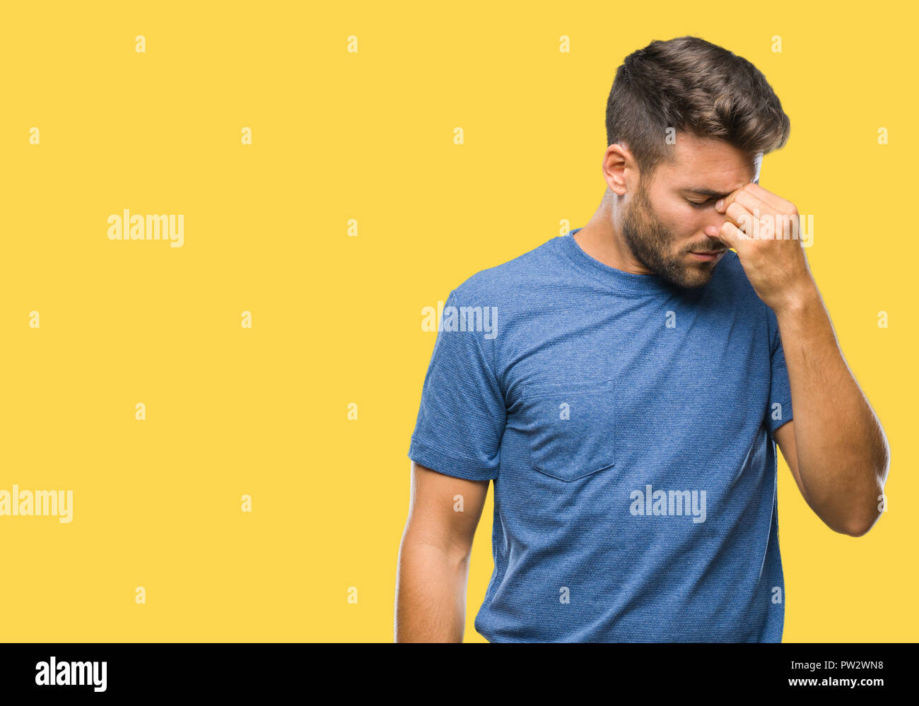 Young handsome man over isolated background tired rubbing nose and eyes ...