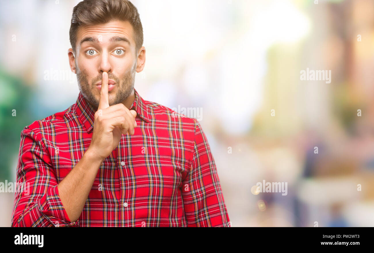 Young handsome man over isolated background asking to be quiet with ...