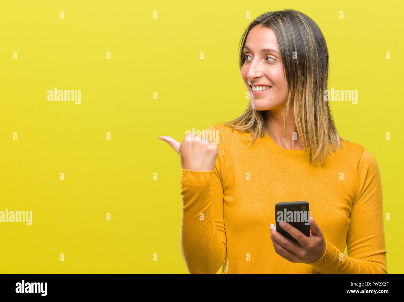 Young beautiful woman sending message using smartphone over isolated ...