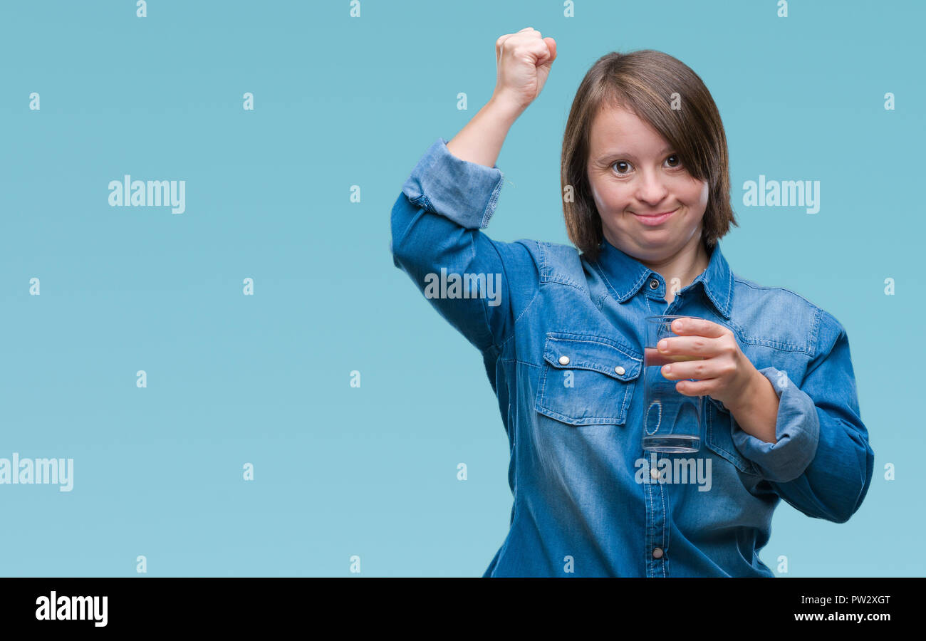 Young adult woman with down syndrome drinking water over isolated ...