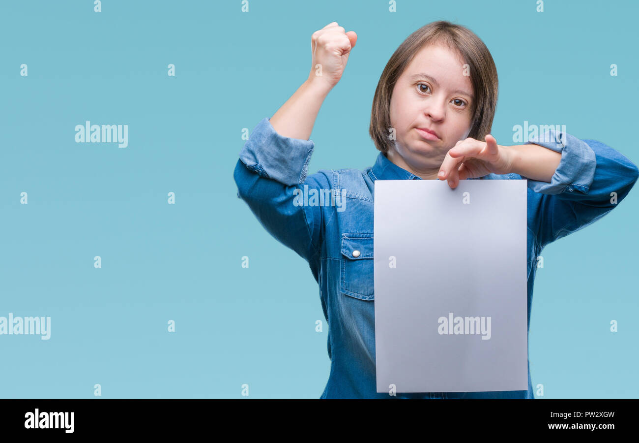 Young adult woman with down syndrome holding blank paper sheet over ...