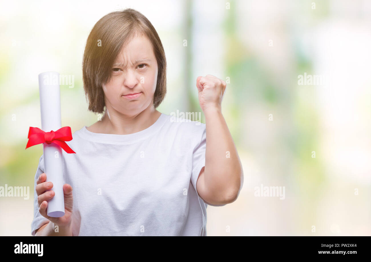 Young adult woman with down syndrome holding degree over isolated ...