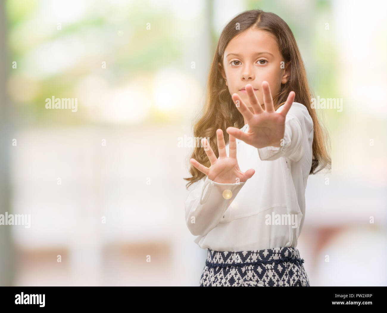 Brunette hispanic girl afraid and terrified with fear expression stop ...