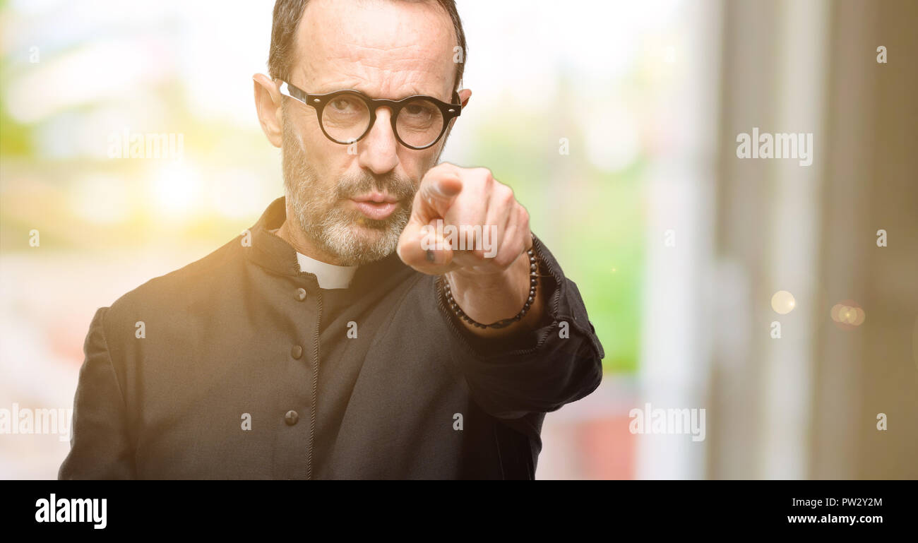 Priest religion man pointing to the front with finger Stock Photo - Alamy