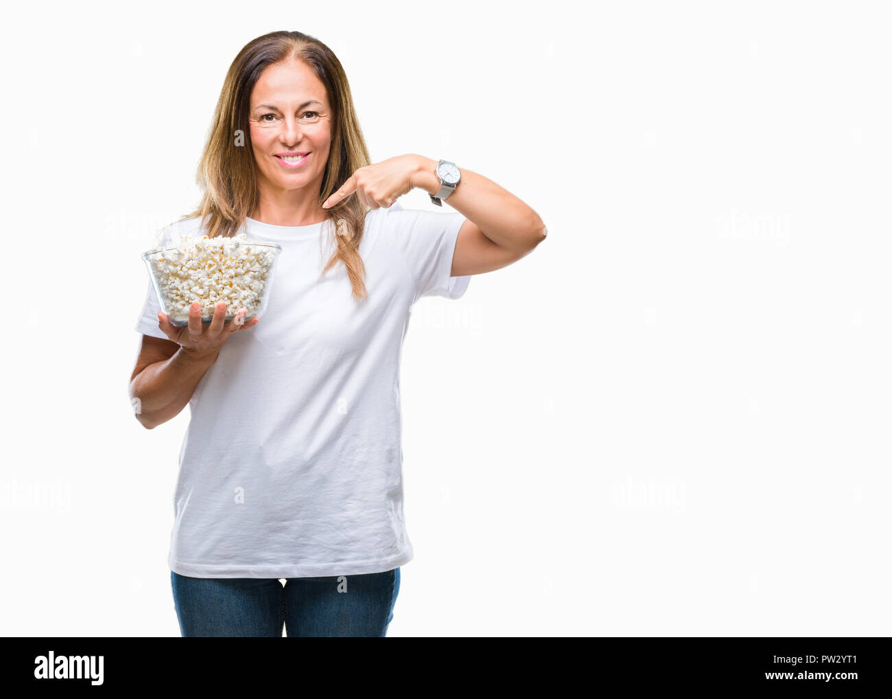 Middle Age Hispanic Woman Eating Popcorn Over Isolated Background With