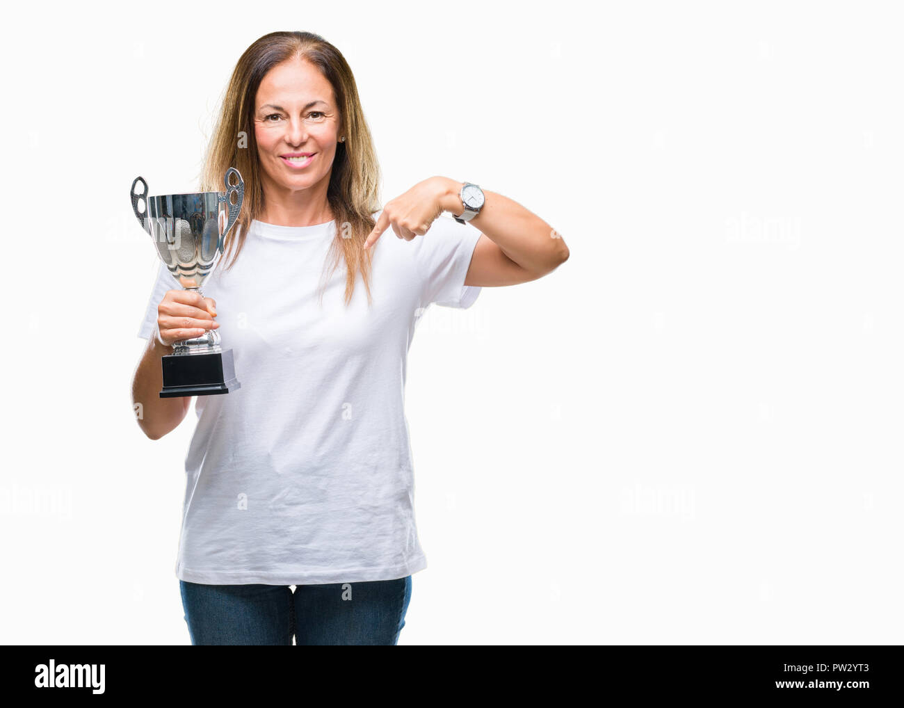 Middle age hispanic winner woman celebrating award holding trophy over ...