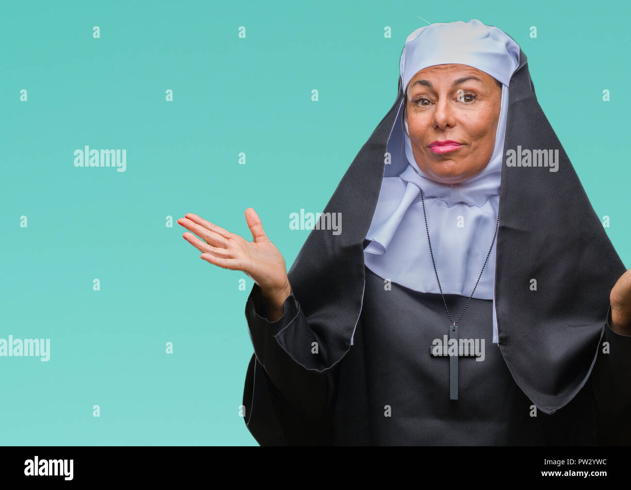 Middle age senior christian catholic nun woman over isolated background ...