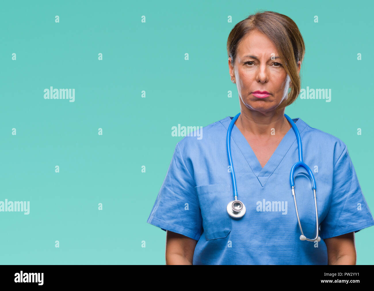 Middle age senior nurse doctor woman over isolated background depressed ...