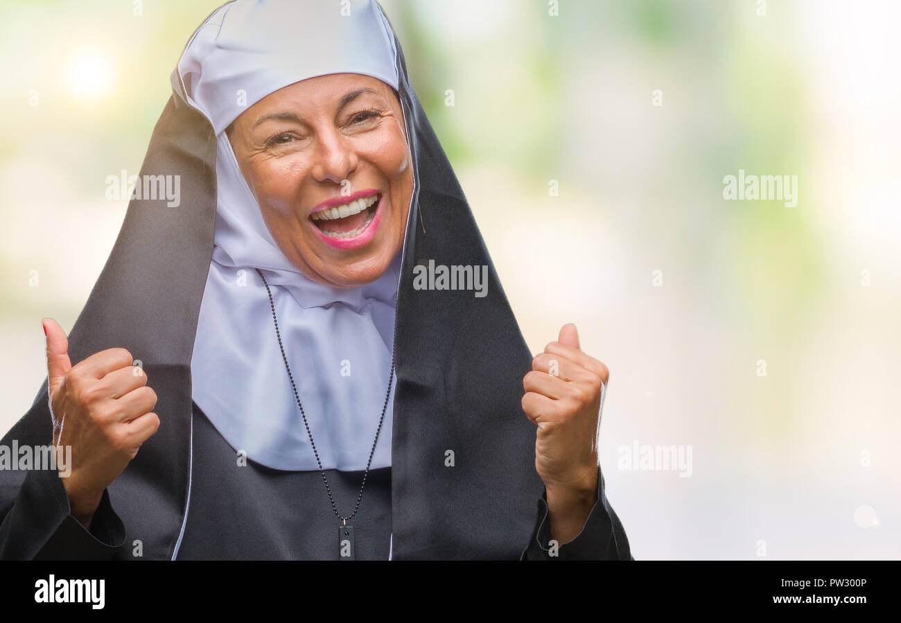 Middle age senior christian catholic nun woman over isolated background ...