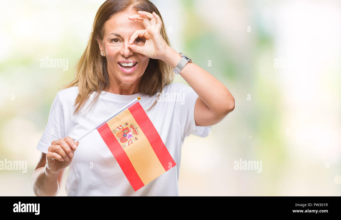 Middle age hispanic woman holding flag of Spain over isolated ...
