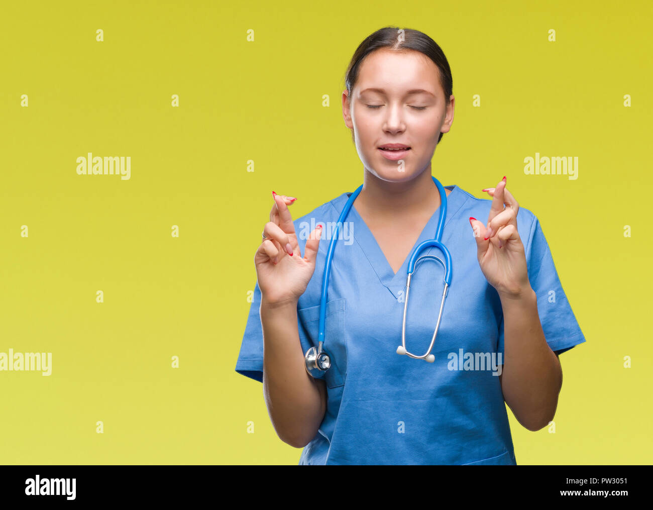 Young caucasian doctor woman wearing medical uniform over isolated ...