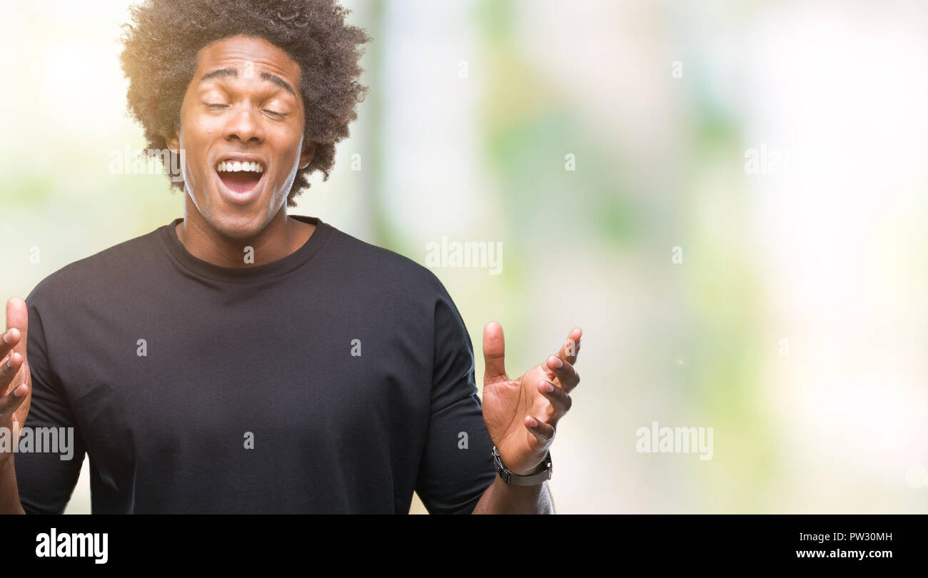 Afro american man over isolated background crazy and mad shouting and ...