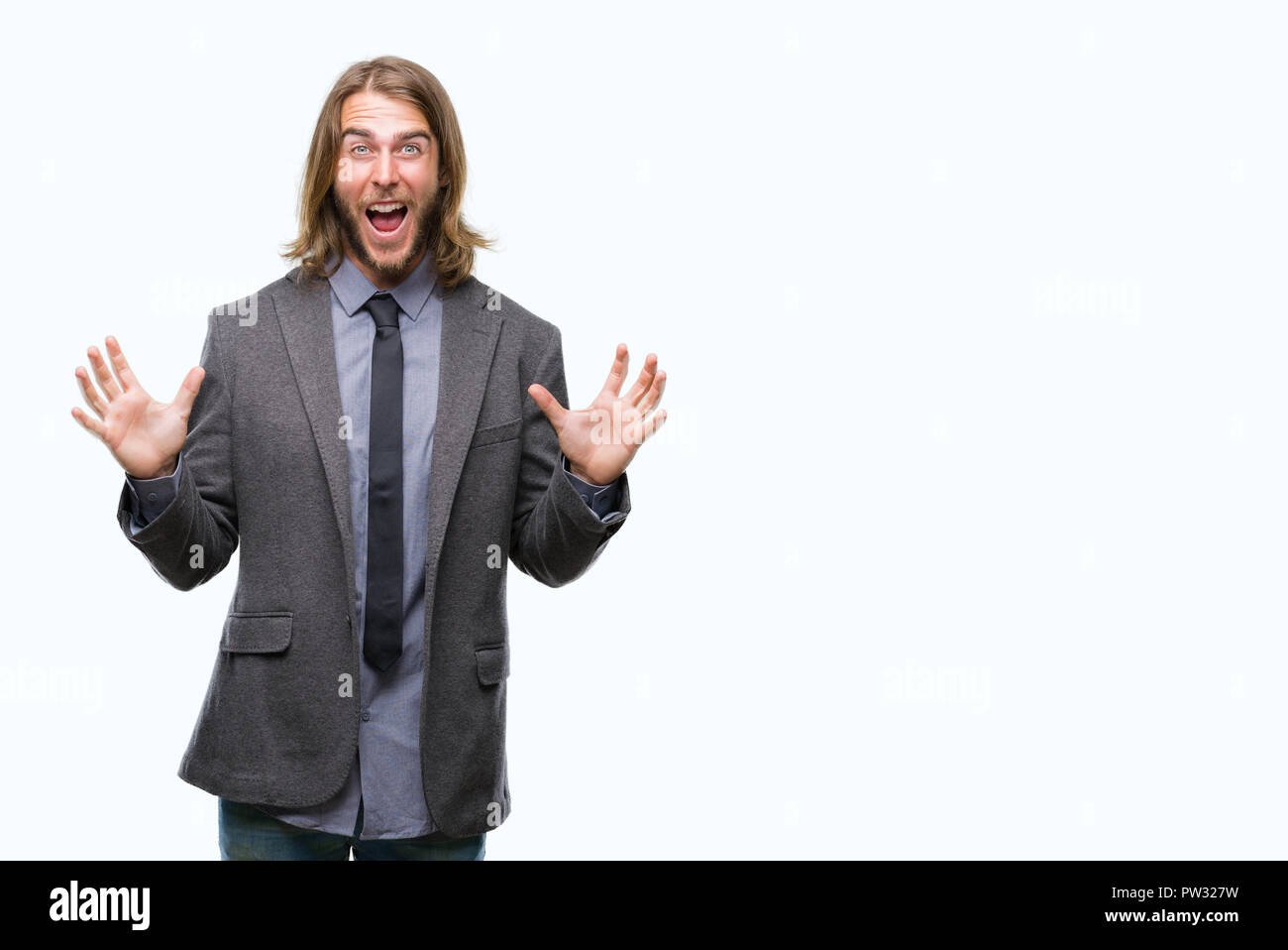 Young handsome business man with long hair over isolated background celebrating crazy and amazed ...