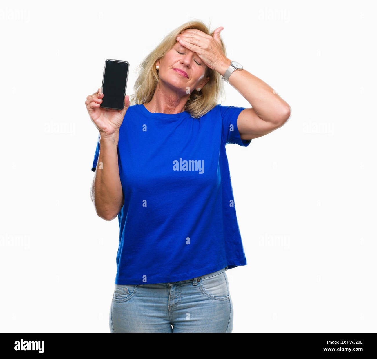 Middle age blonde woman showing blank screen of smartphone over ...