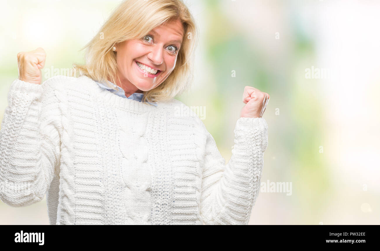 Middle age blonde woman wearing winter sweater over isolated background ...