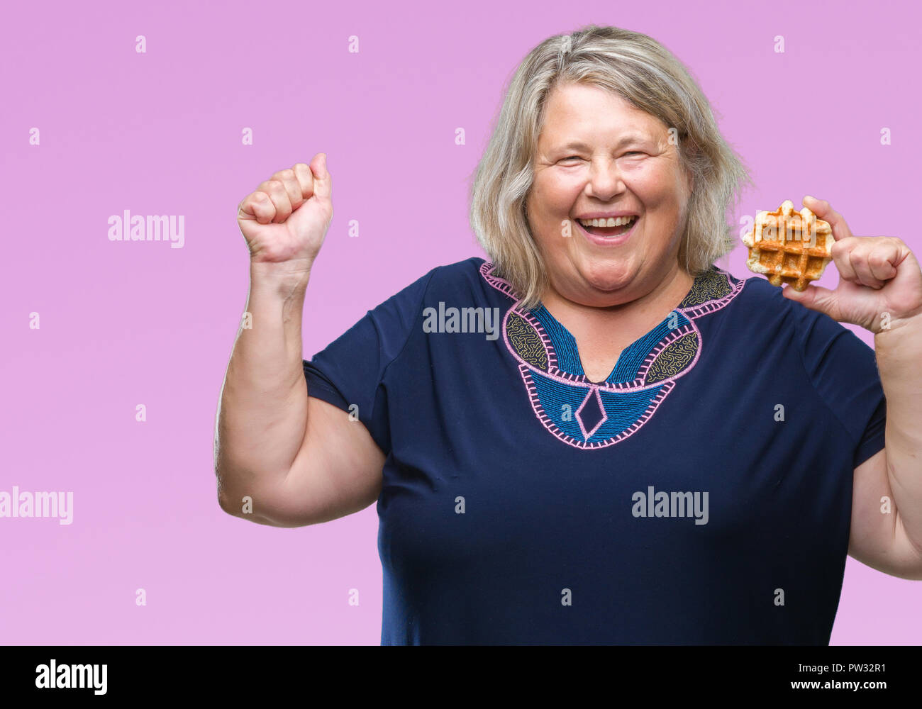 Senior plus size caucasian woman eating waffle over isolated background ...