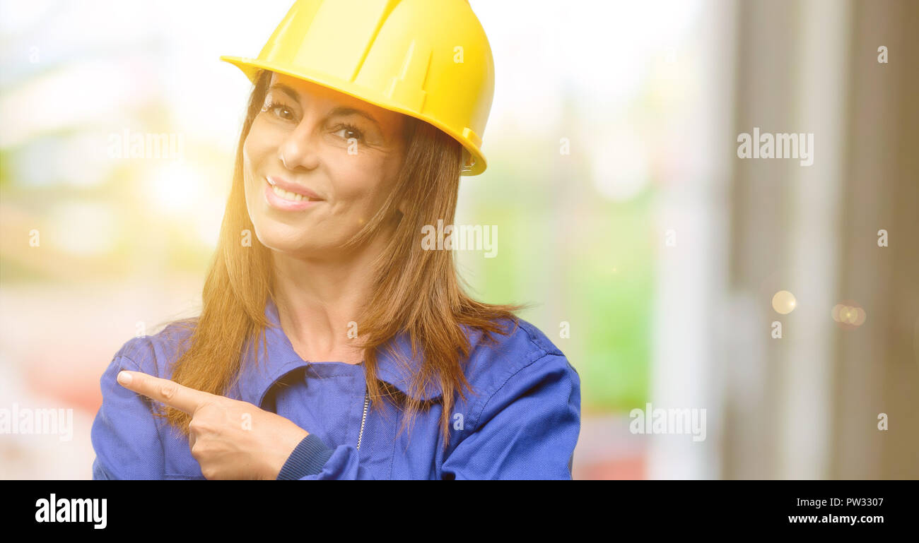 Engineer construction worker woman pointing away side with finger Stock ...