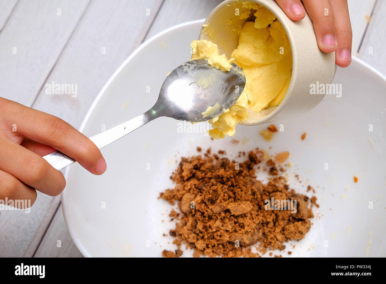 An Asean handsome teen boy pouring butter for making famous amous. Food ...