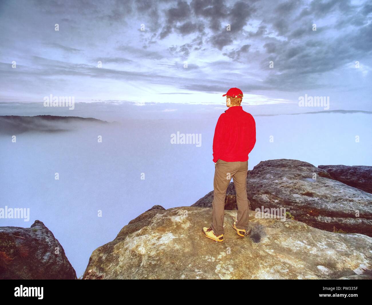 Tall guy with hands in pocket in blue shirt standing and watch the ...