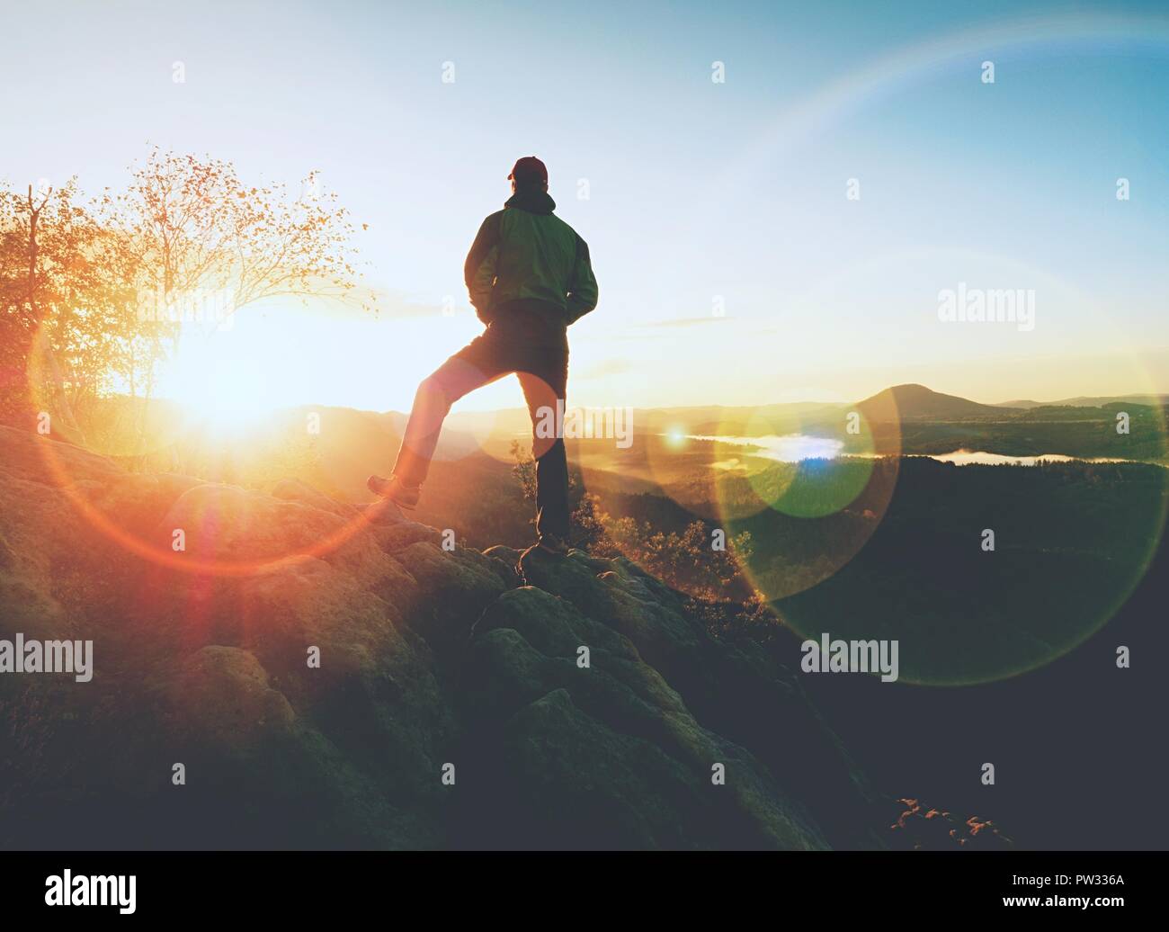 Man walking on the edge of a cliff at summit. Hrensko range, Czech ...