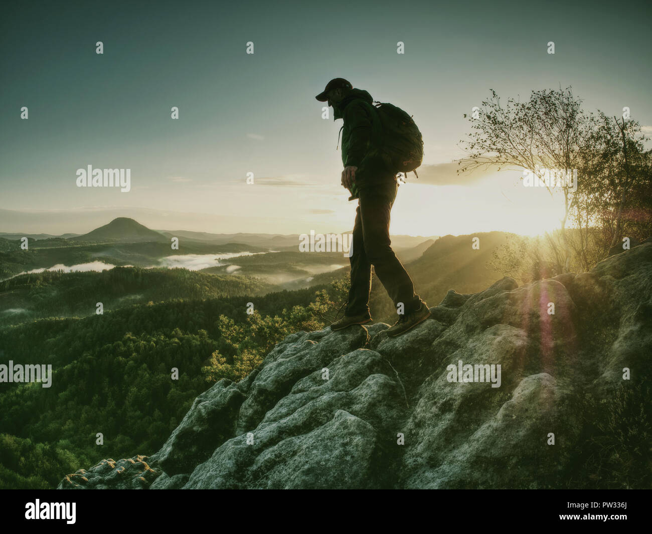 Climbing hiker with backpack in mountains. Rock climber in ...