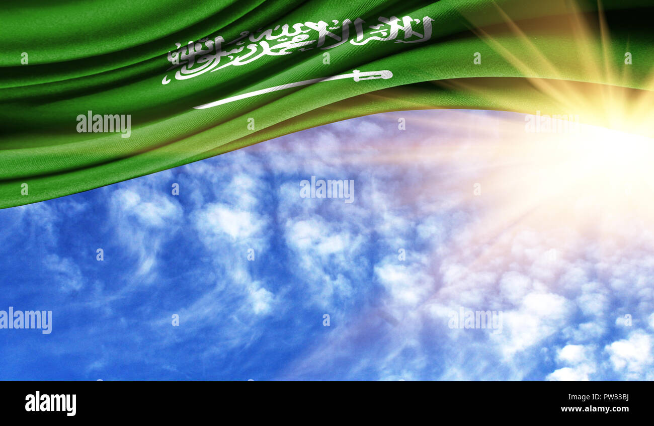 the flag of Saudi Arabia in the rays of the summer sun, in the sky ...