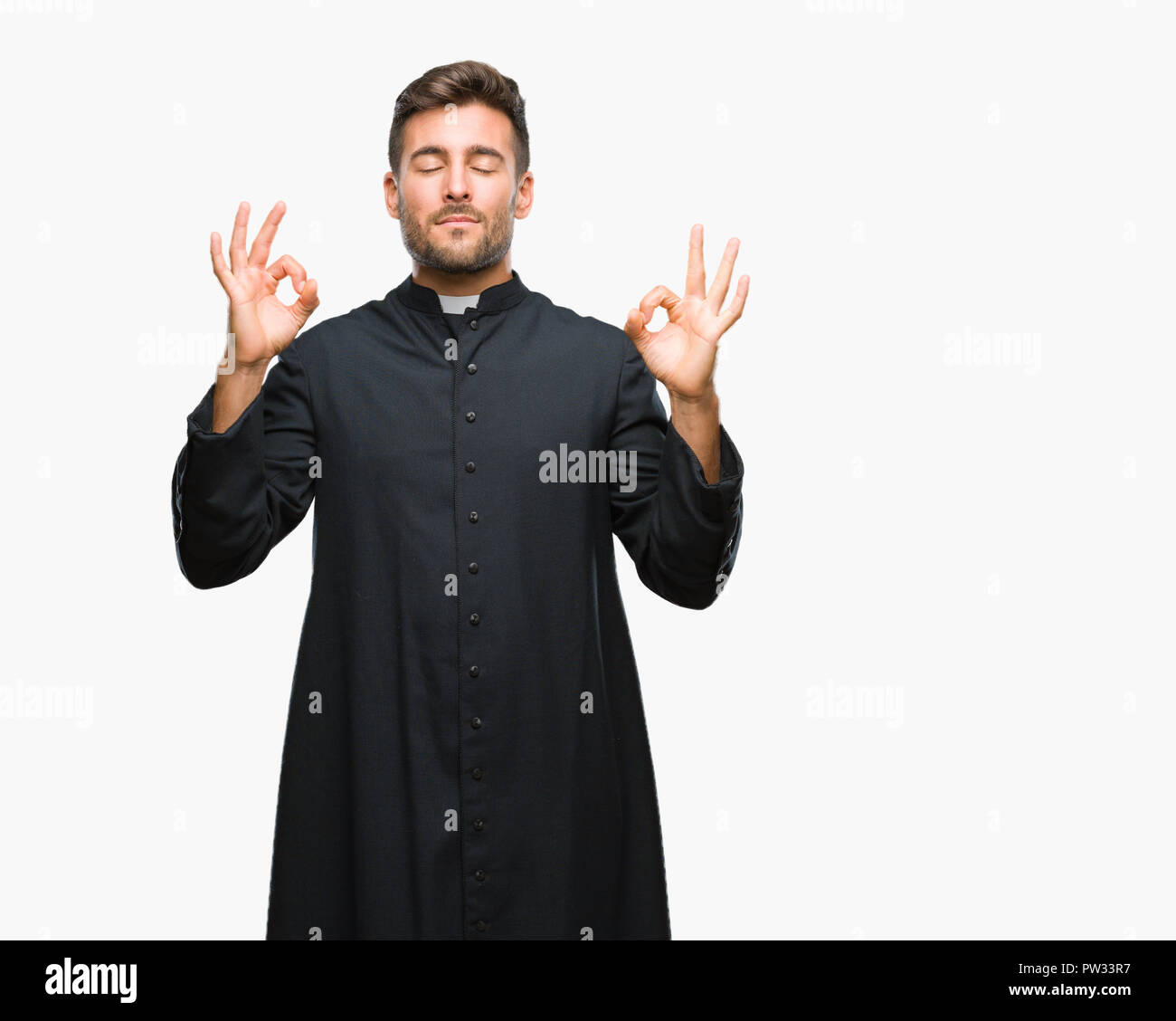 Young catholic christian priest man over isolated background relax and ...