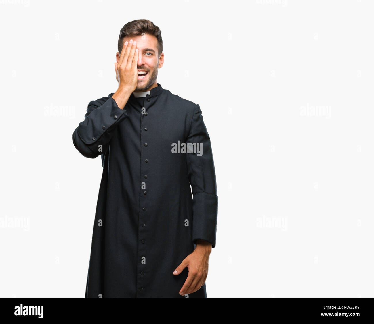 Young catholic christian priest man over isolated background covering ...