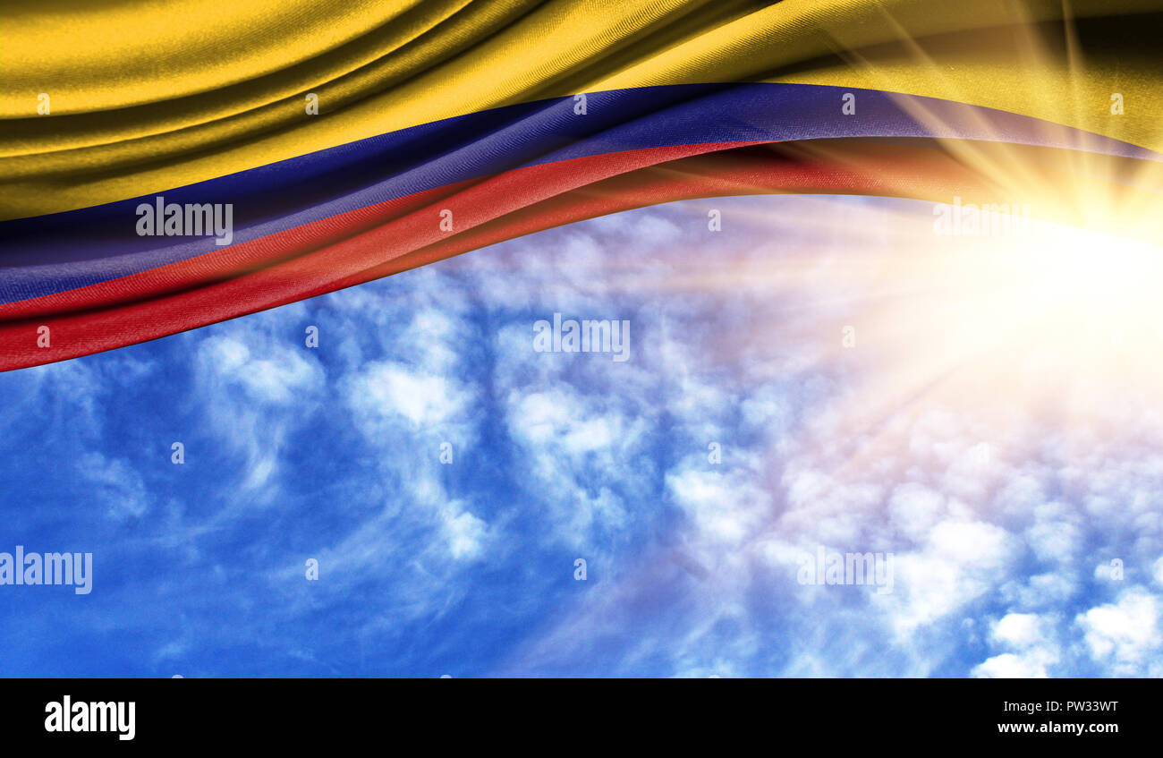 the flag of Colombia in the rays of the summer sun, in the sky ...