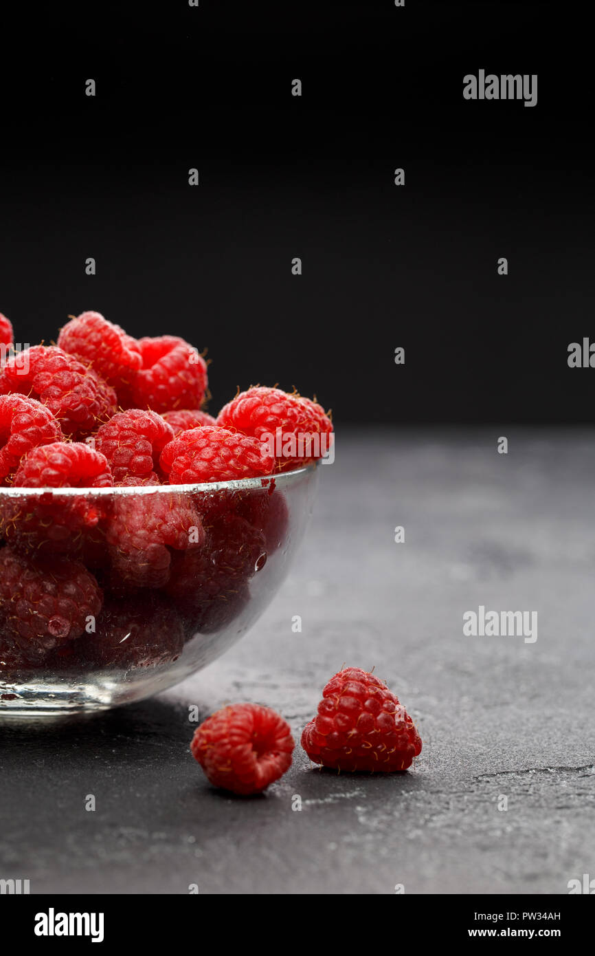 Photo of raspberries in transparent glass cup Stock Photo - Alamy