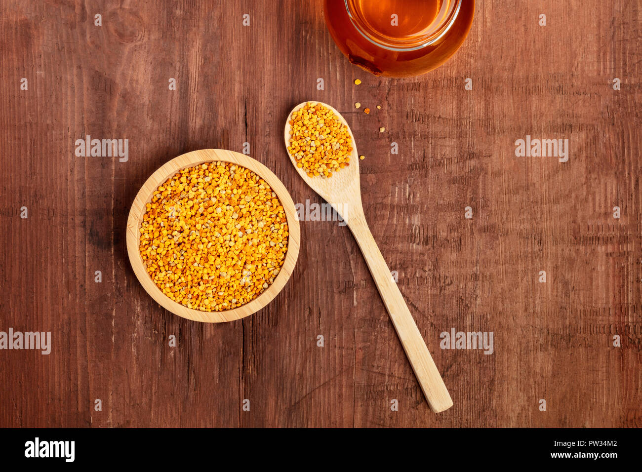 Healthy organic food. A top shot of pollen, a jar of honey, and a ...