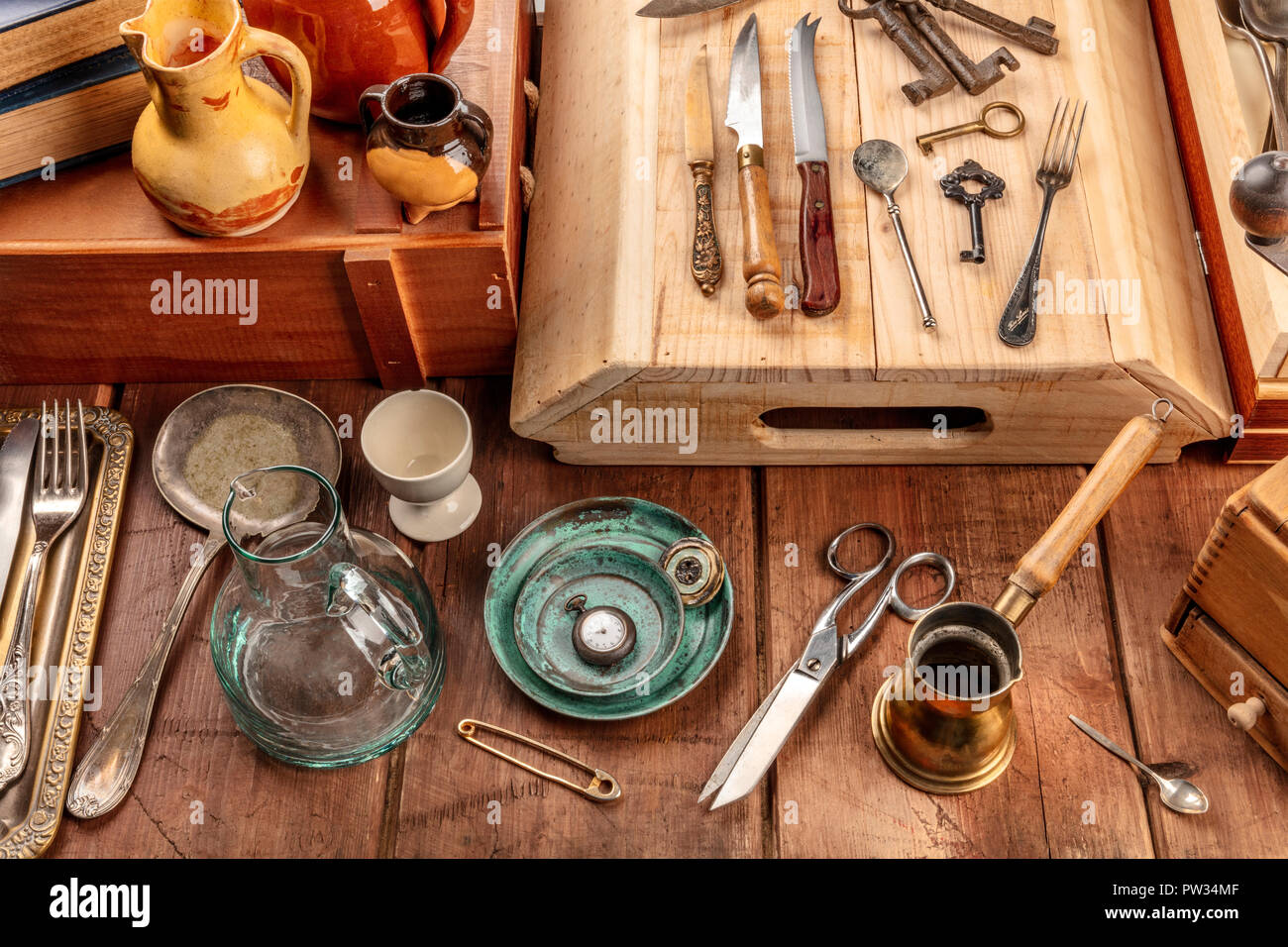 A photo of many vintage objects, flea market stuff on a wooden stand ...