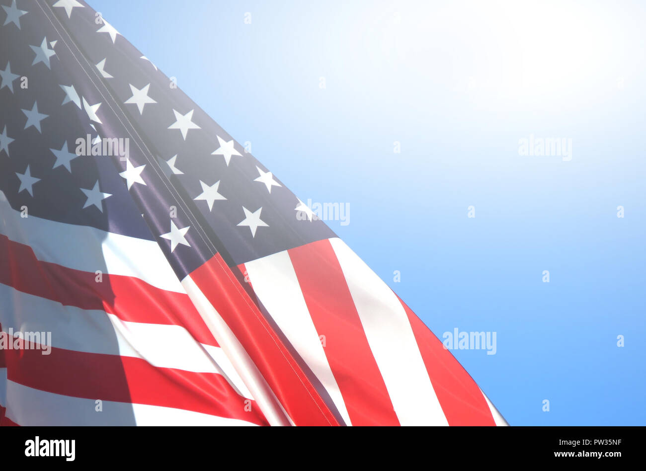 flag of America against the blue sky with sun rays Stock Photo - Alamy