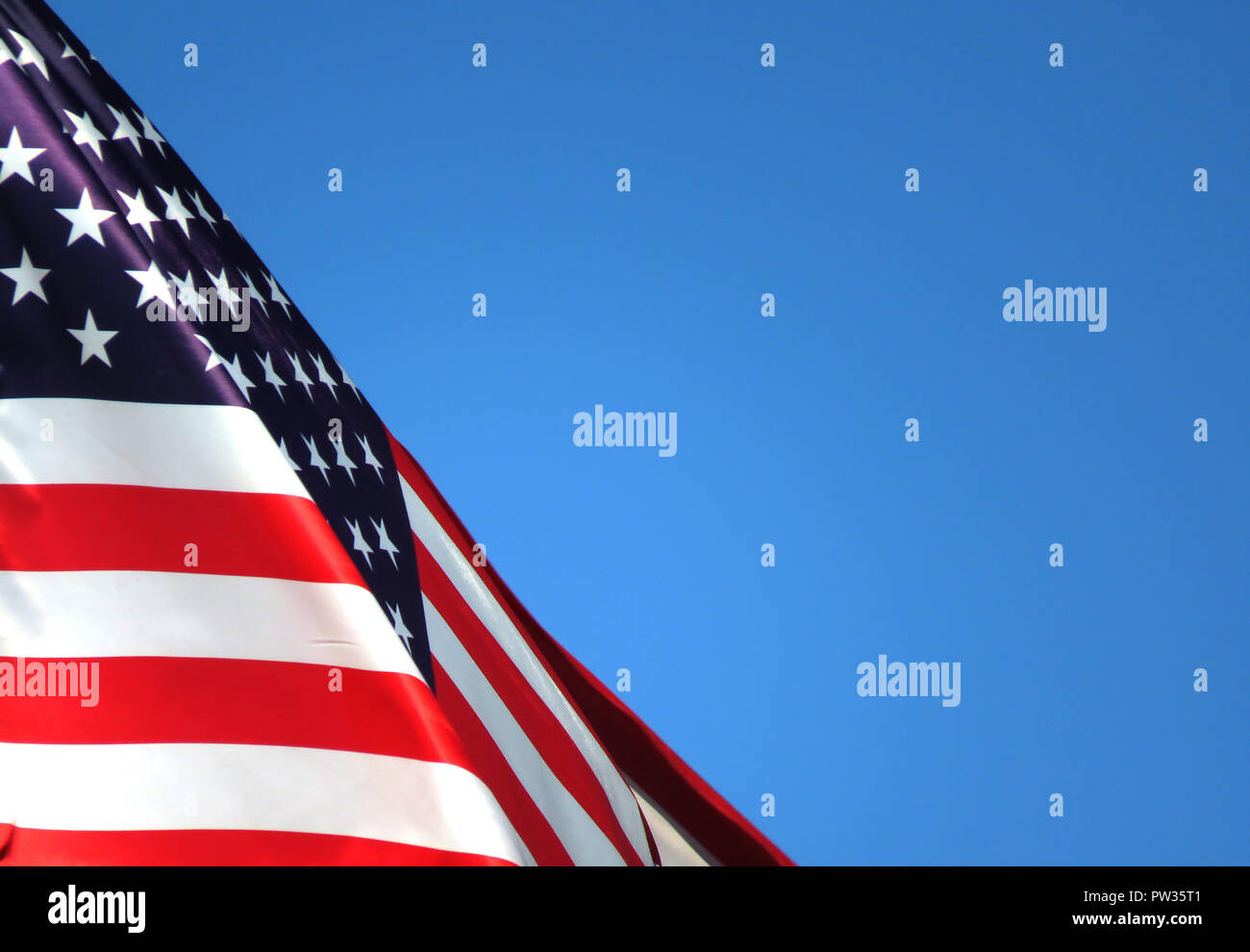 Realistic flag of America on the wavy surface of fabric. This flag can ...