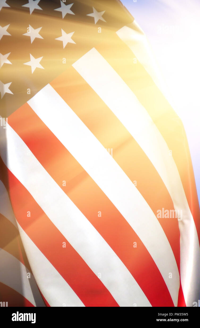 flag of America against the blue sky with sun rays Stock Photo - Alamy